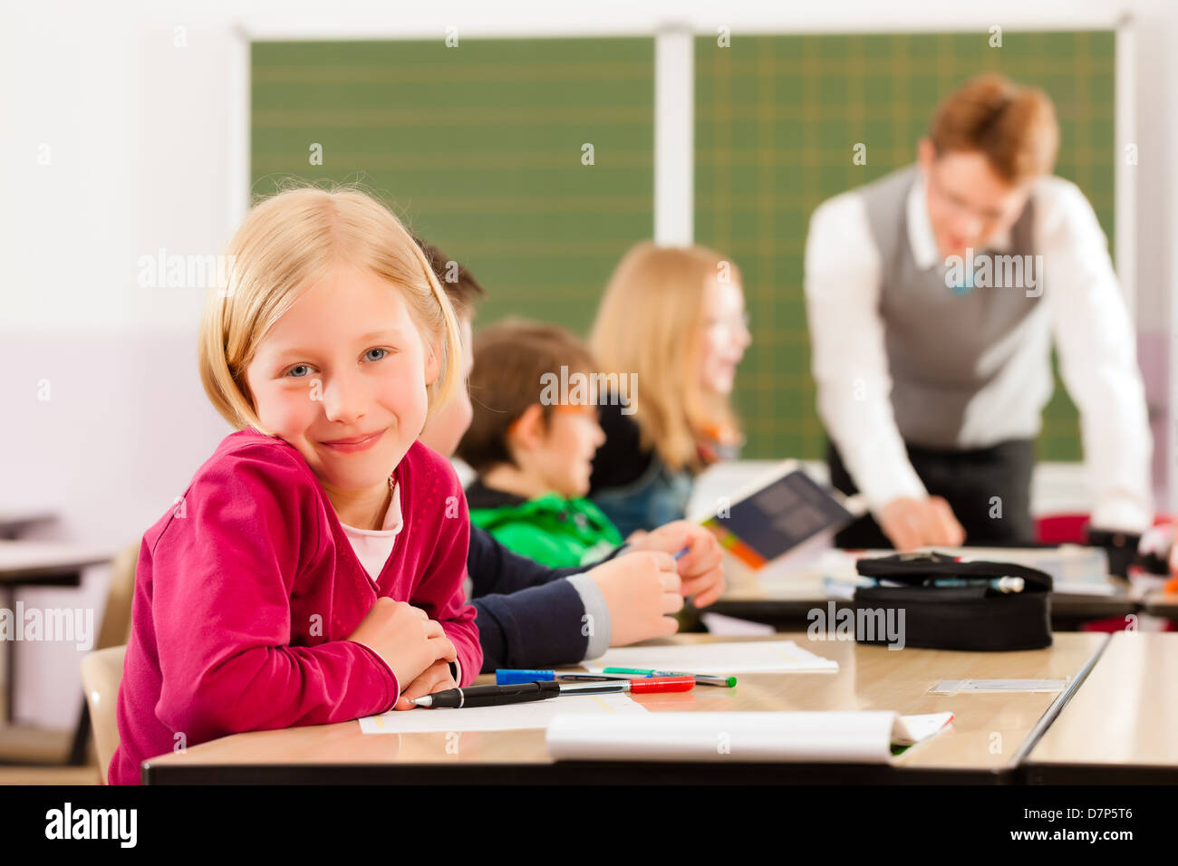 Education - Pupils and teacher learning at elementary or primary school ...