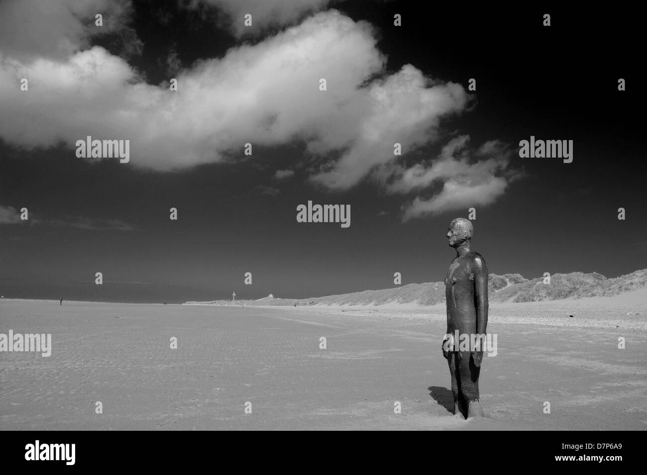Antony Gormley's Another Place statues on the beach at Crosby with ...