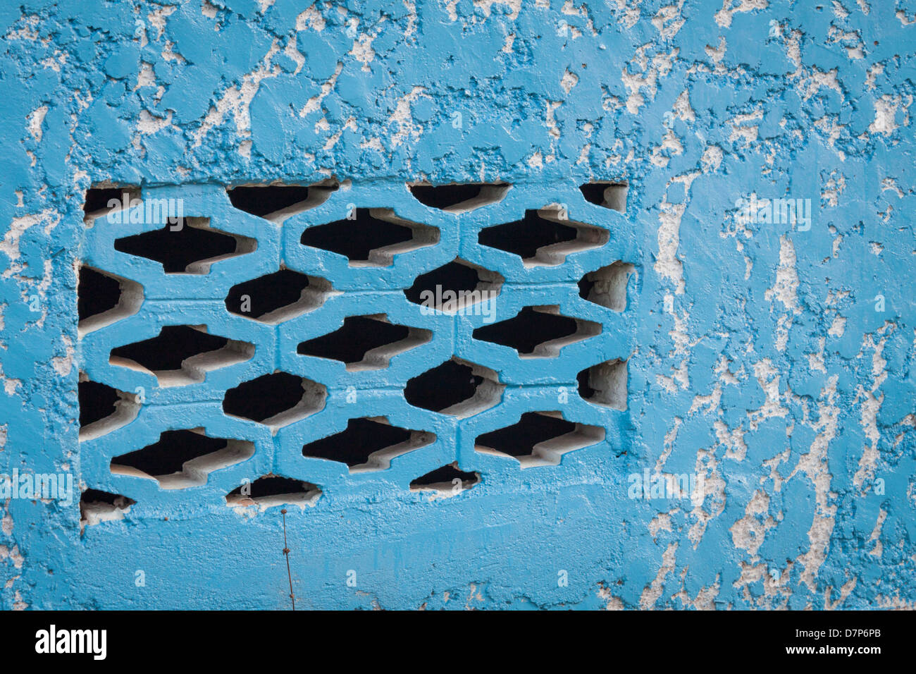 Blue aged street wall with black brick holes Stock Photo - Alamy