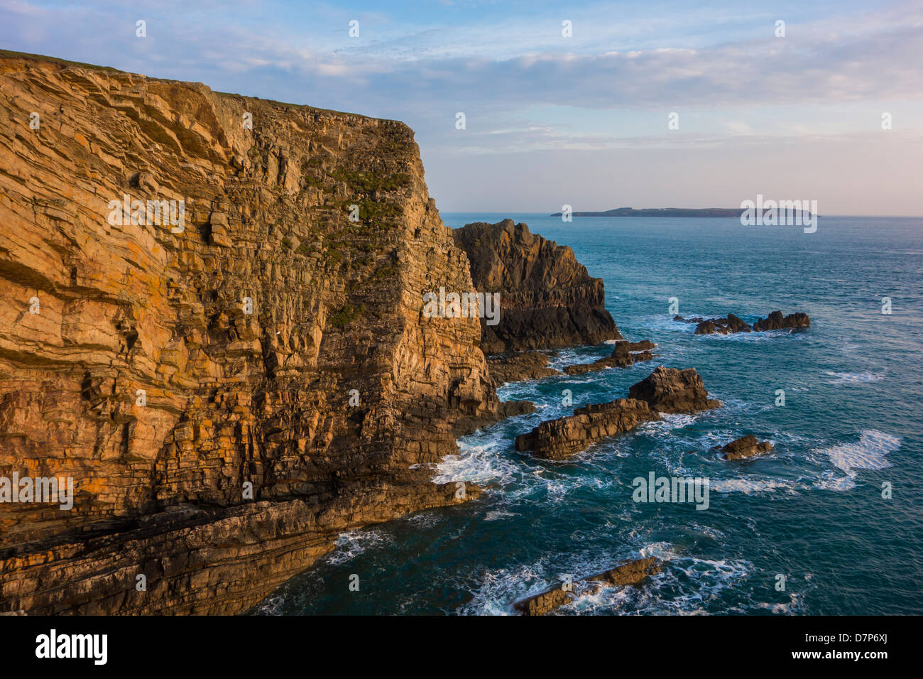 Dramatic cliff faces with Skokholm Island in the background ...