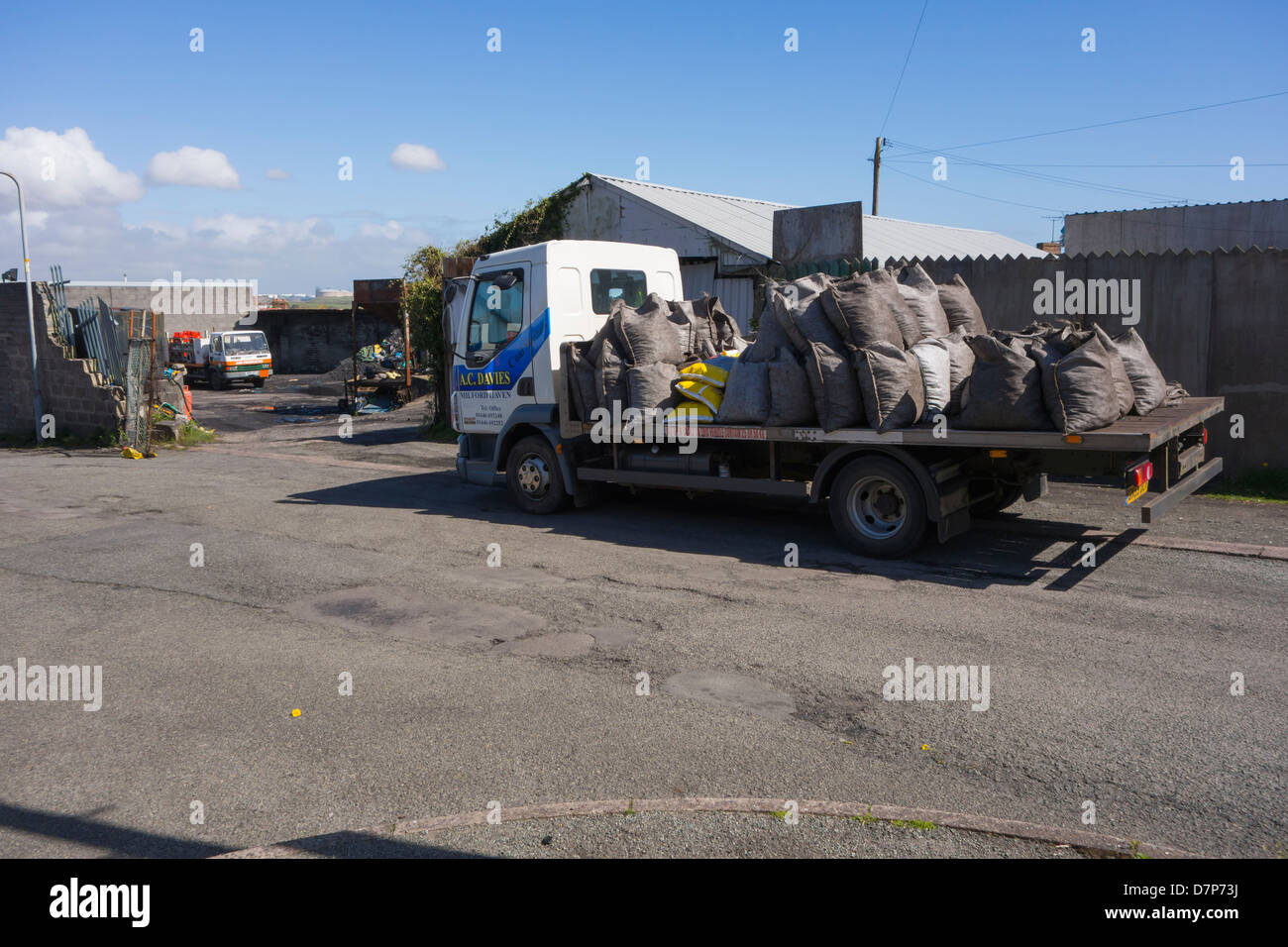Coal merchants truck outside coal yard, loaded with sacks of coal ready ...