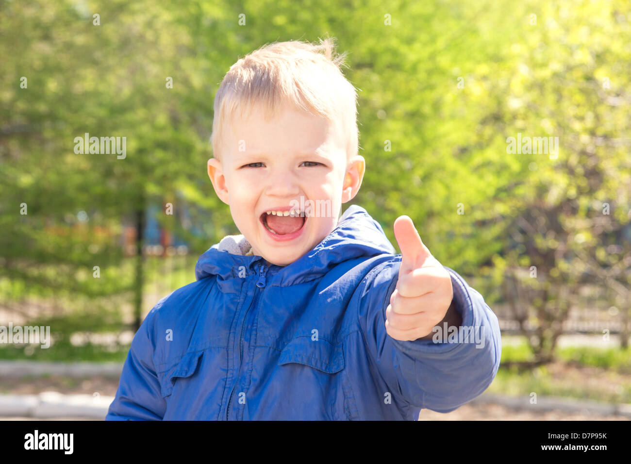 Happy smiling joyful beautiful child (little boy) outdoor in spring ...
