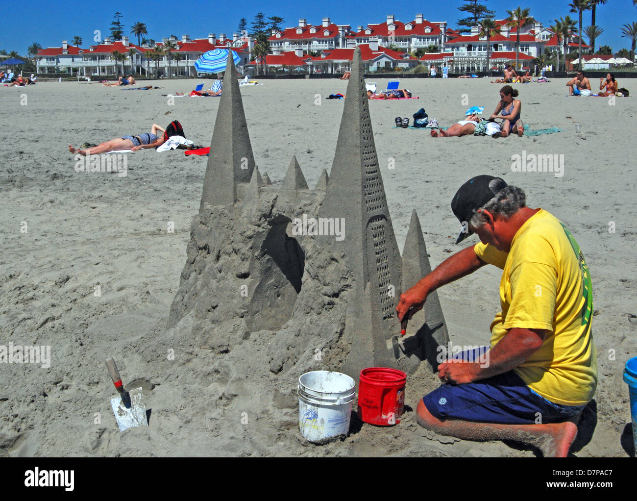 Man building sand castle in Catalina, California on the beach outside ...