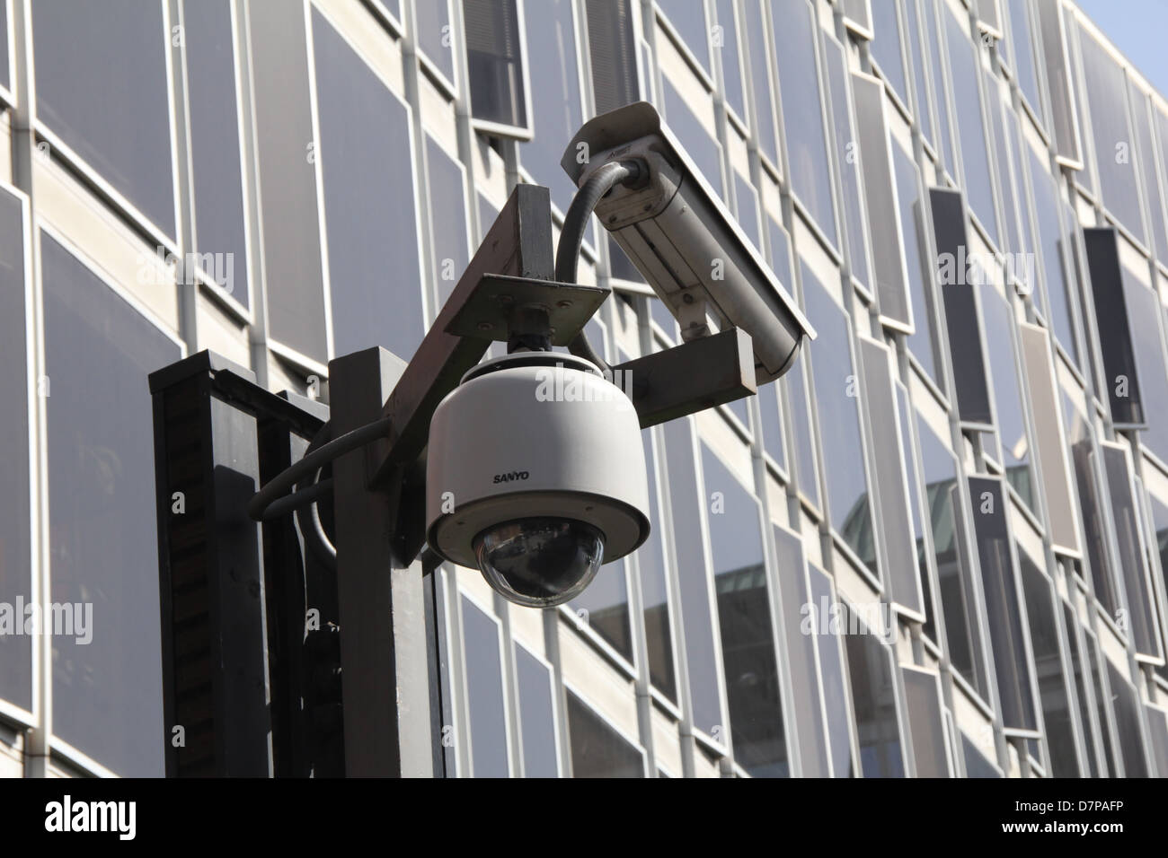 glass office block and cctv camera in city town Stock Photo - Alamy