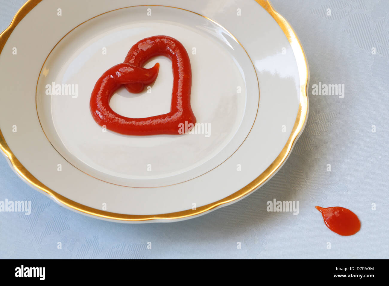 Image of ketchup heart with tear on dinner plate Stock Photo - Alamy