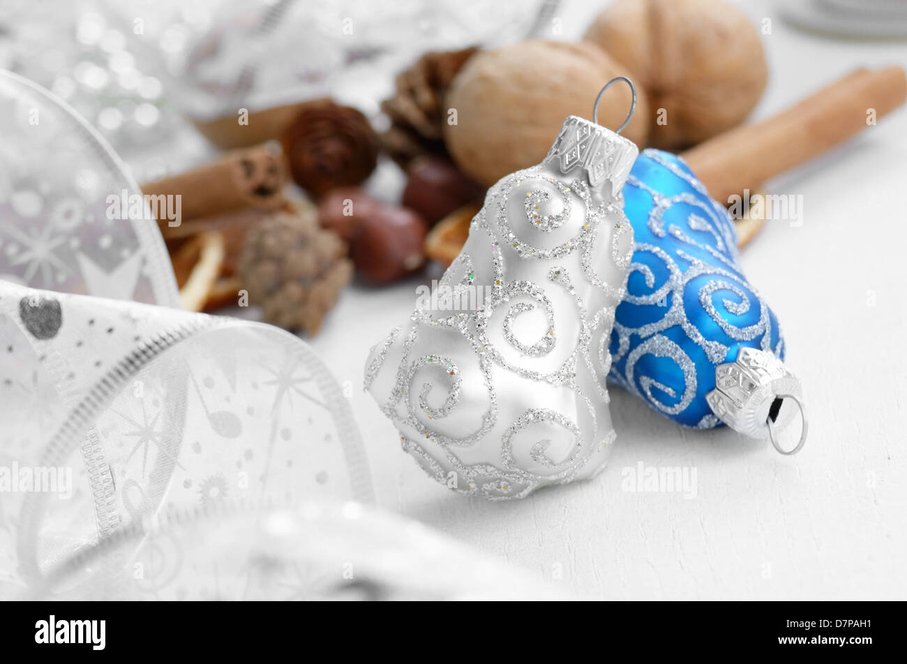 Christmas glass fir cones with spices and ribbon on white table Stock ...