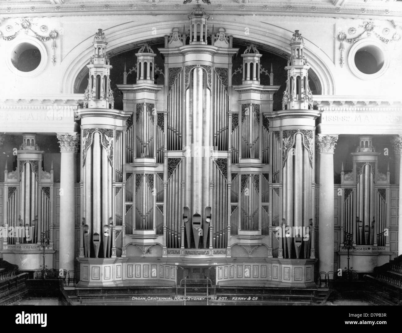 This black-and-white photograph shows the ornate pipe organ located in ...
