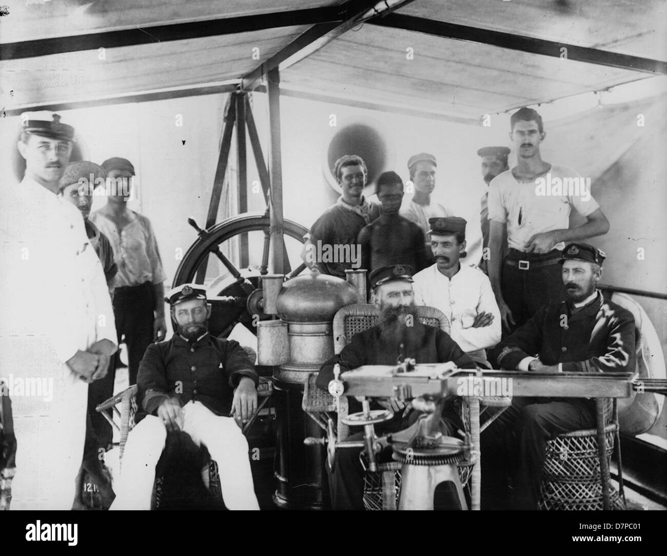 This historical photograph shows the ferry crew at the bridge of a boat ...