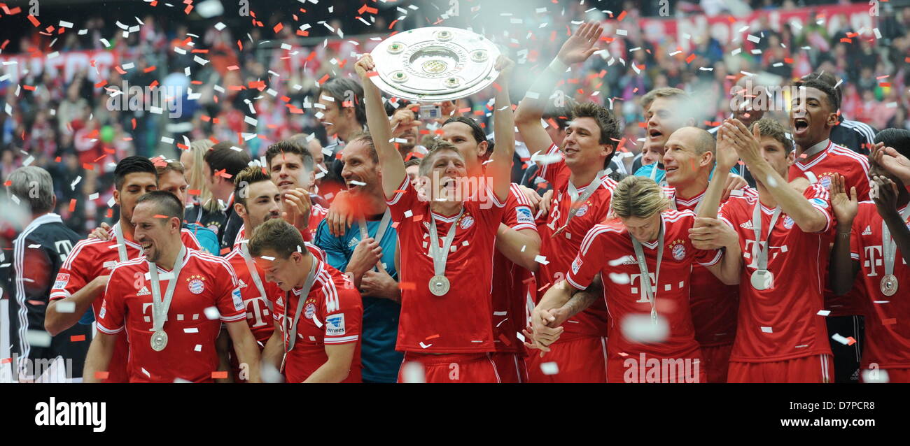 Bayern Munich's Bastian Schweinsteiger holds the championship shield ...