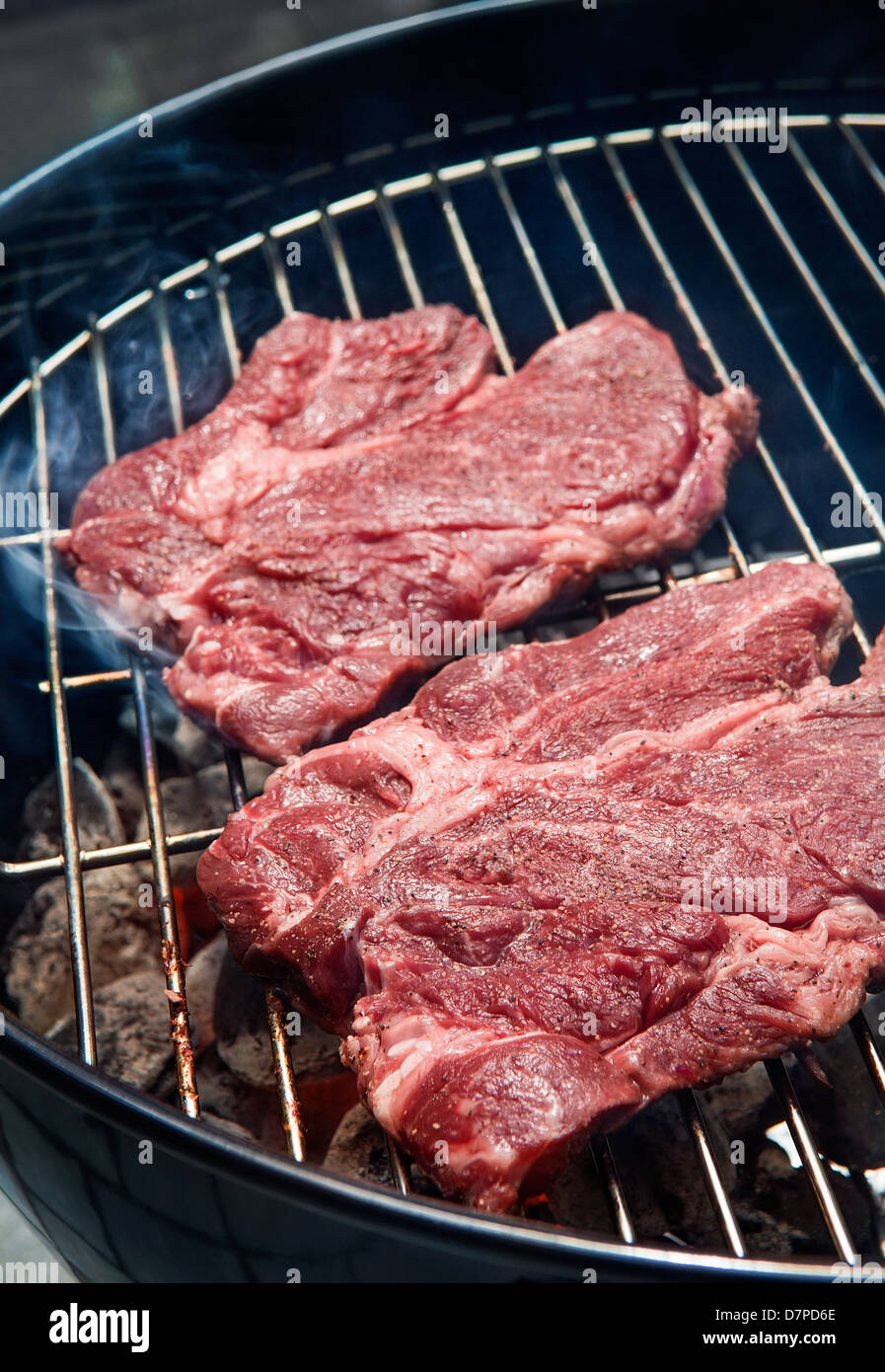 Two beef steaks on grill Stock Photo - Alamy