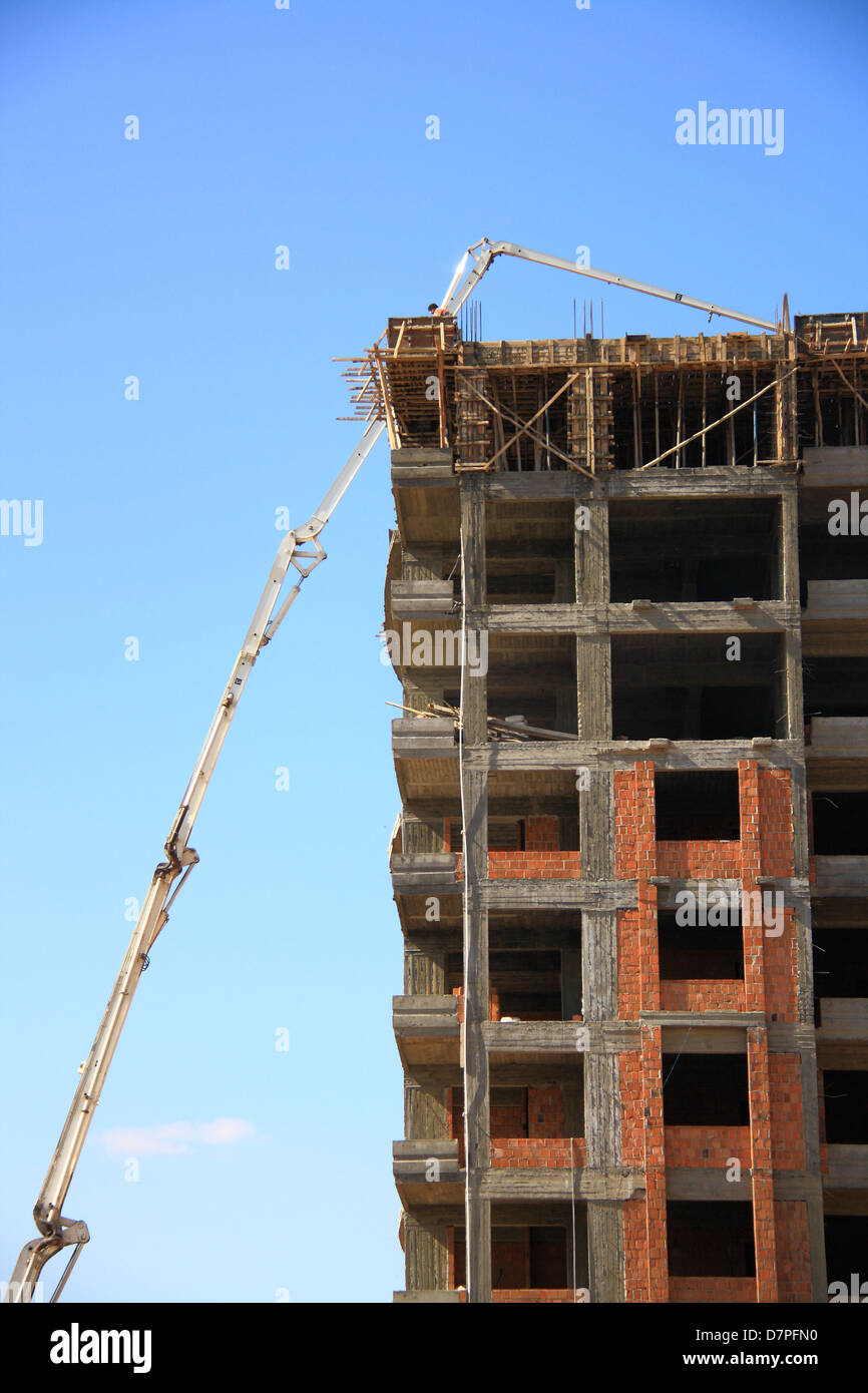 construction of building with cement mixture machine Stock Photo - Alamy
