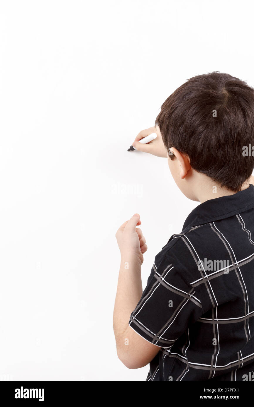 young boy student in a classroom writing on a empty whiteboard Stock ...