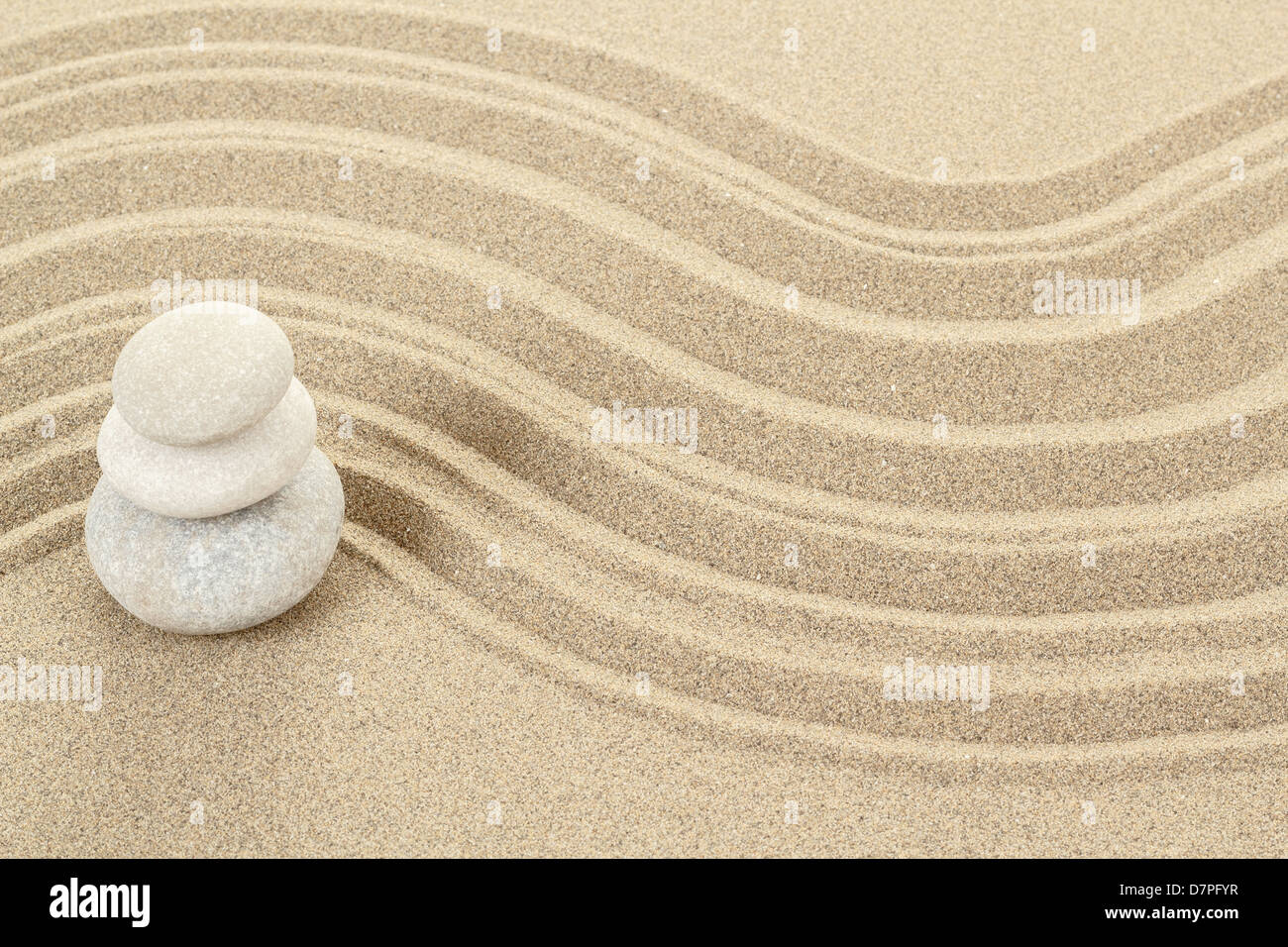 Balance of three zen stones in sand Stock Photo - Alamy