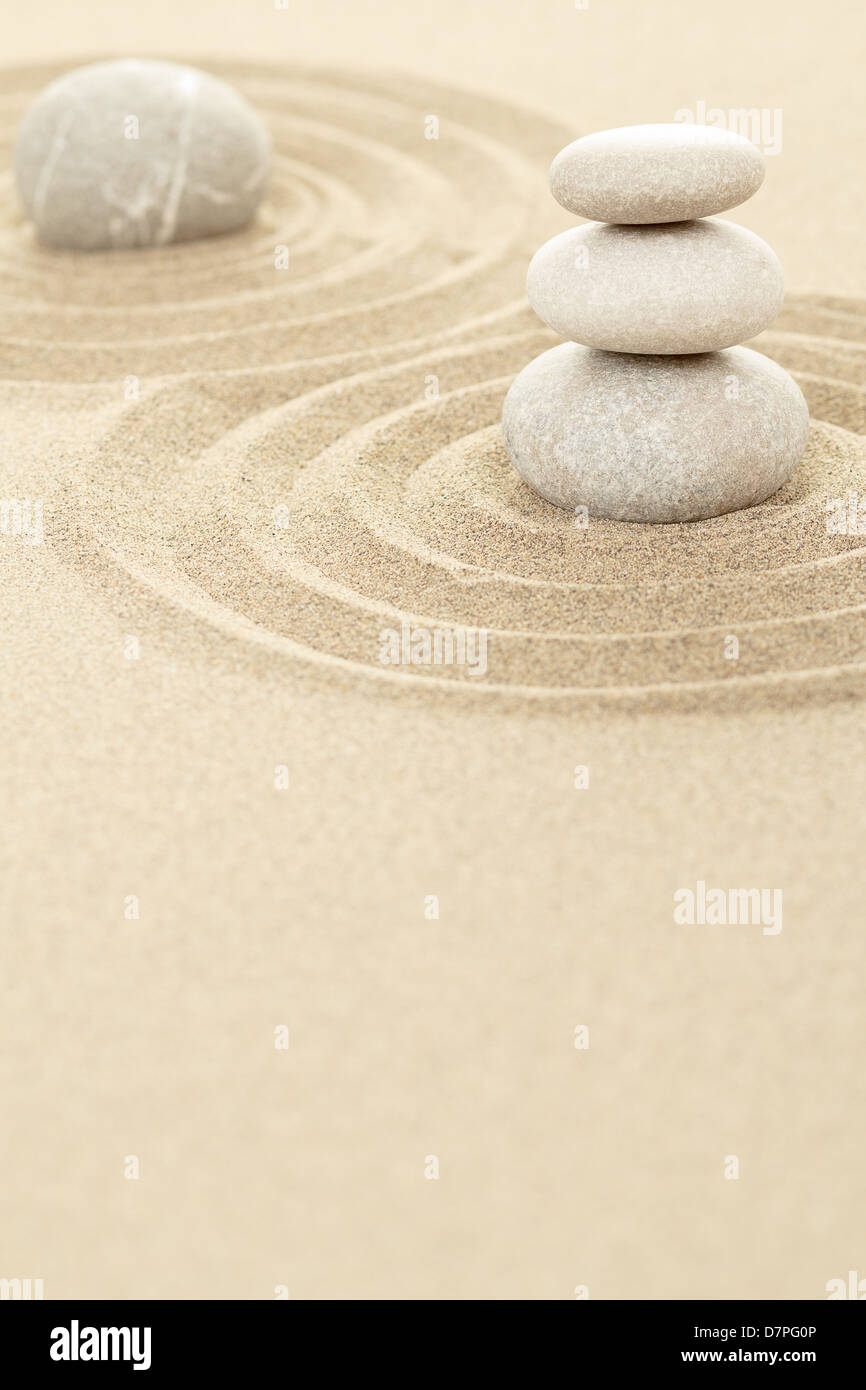 Balance of three zen stones in sand Stock Photo - Alamy
