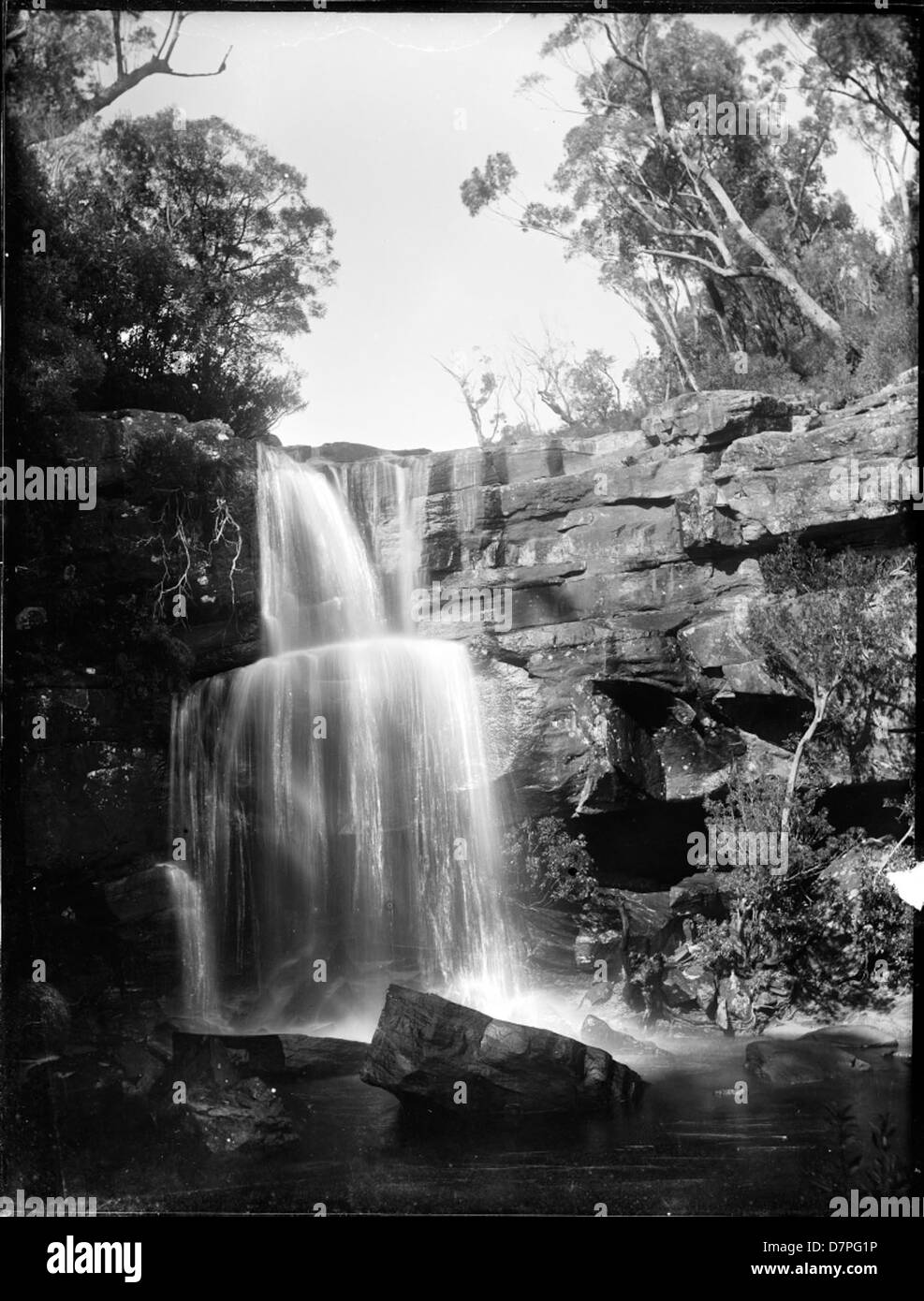 This image features a dramatic view of a waterfall, captured with rich ...