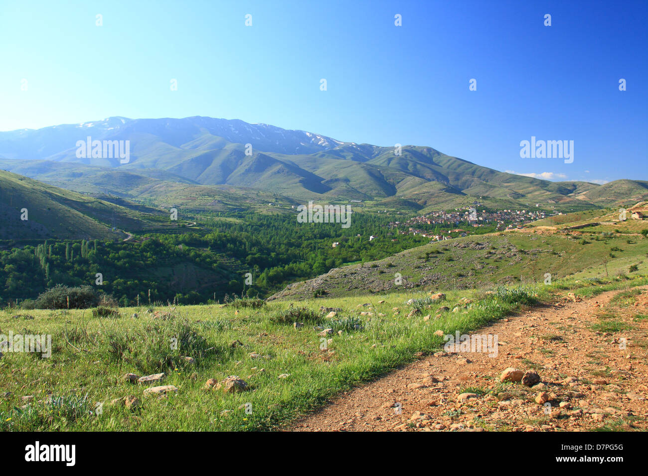 village between hills on spring day with blue sky Stock Photo - Alamy