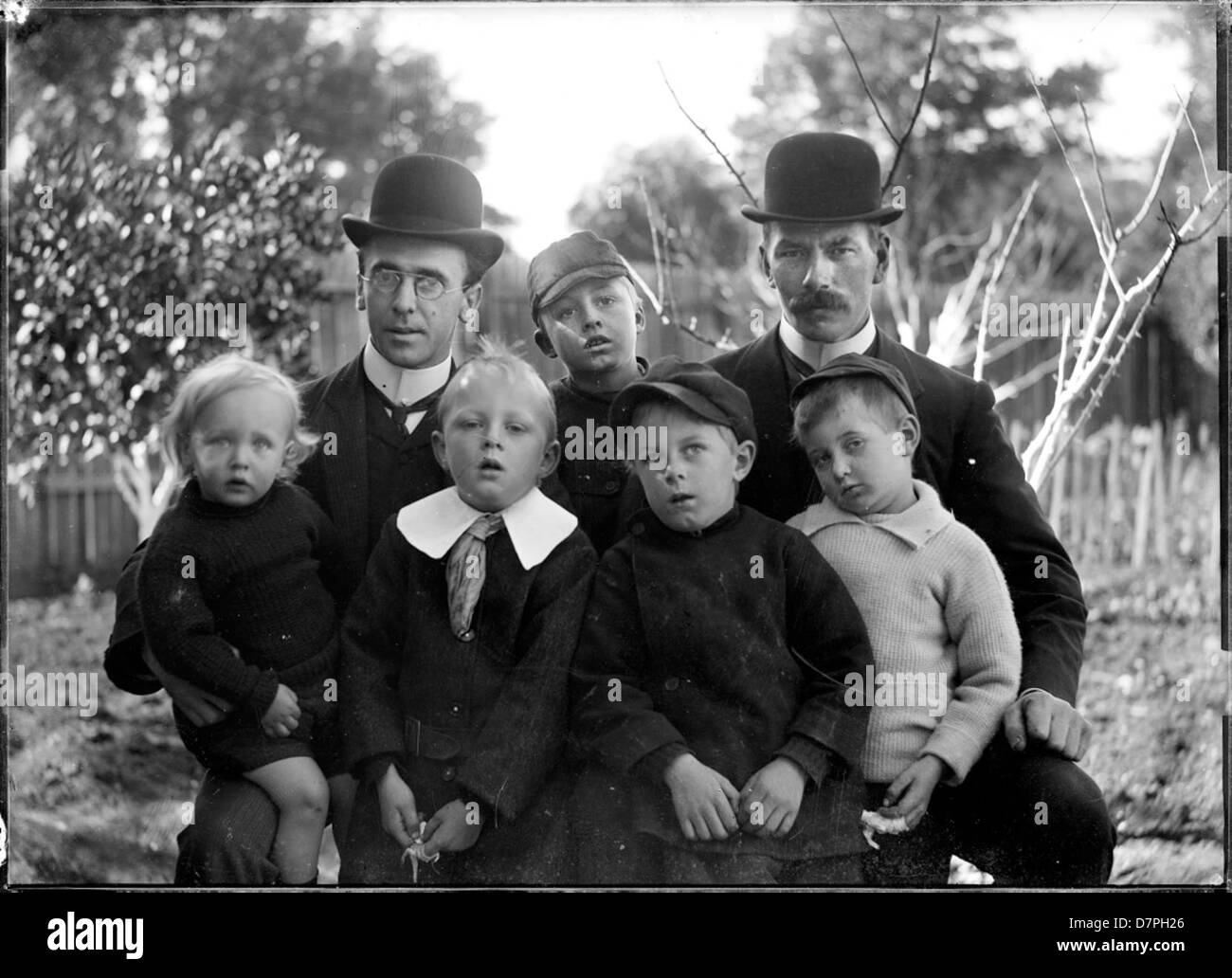 A historical black-and-white portrait featuring two men in bowler hats ...