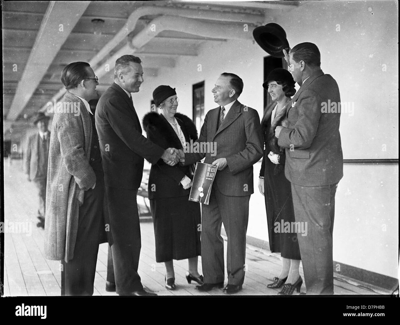 The photograph captures a group of individuals aboard a ship ...
