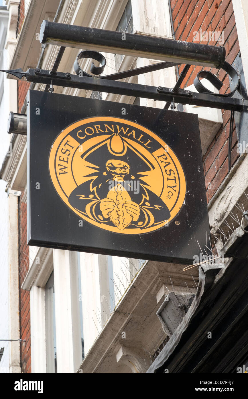 Looking up at West Cornwall Pasty company sign above UK high street ...