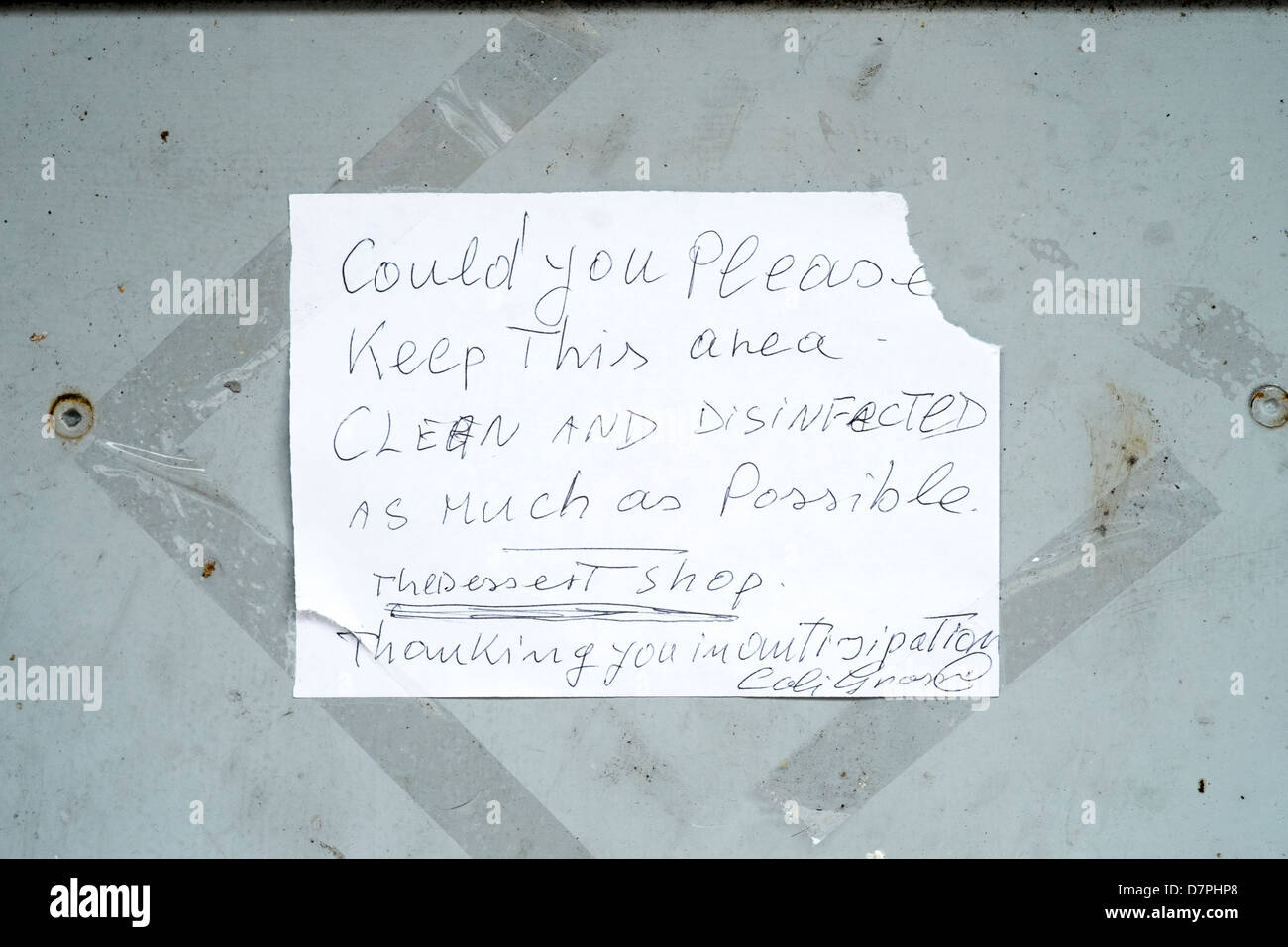 Hand written paper note with torn corner taped to a door Stock Photo ...