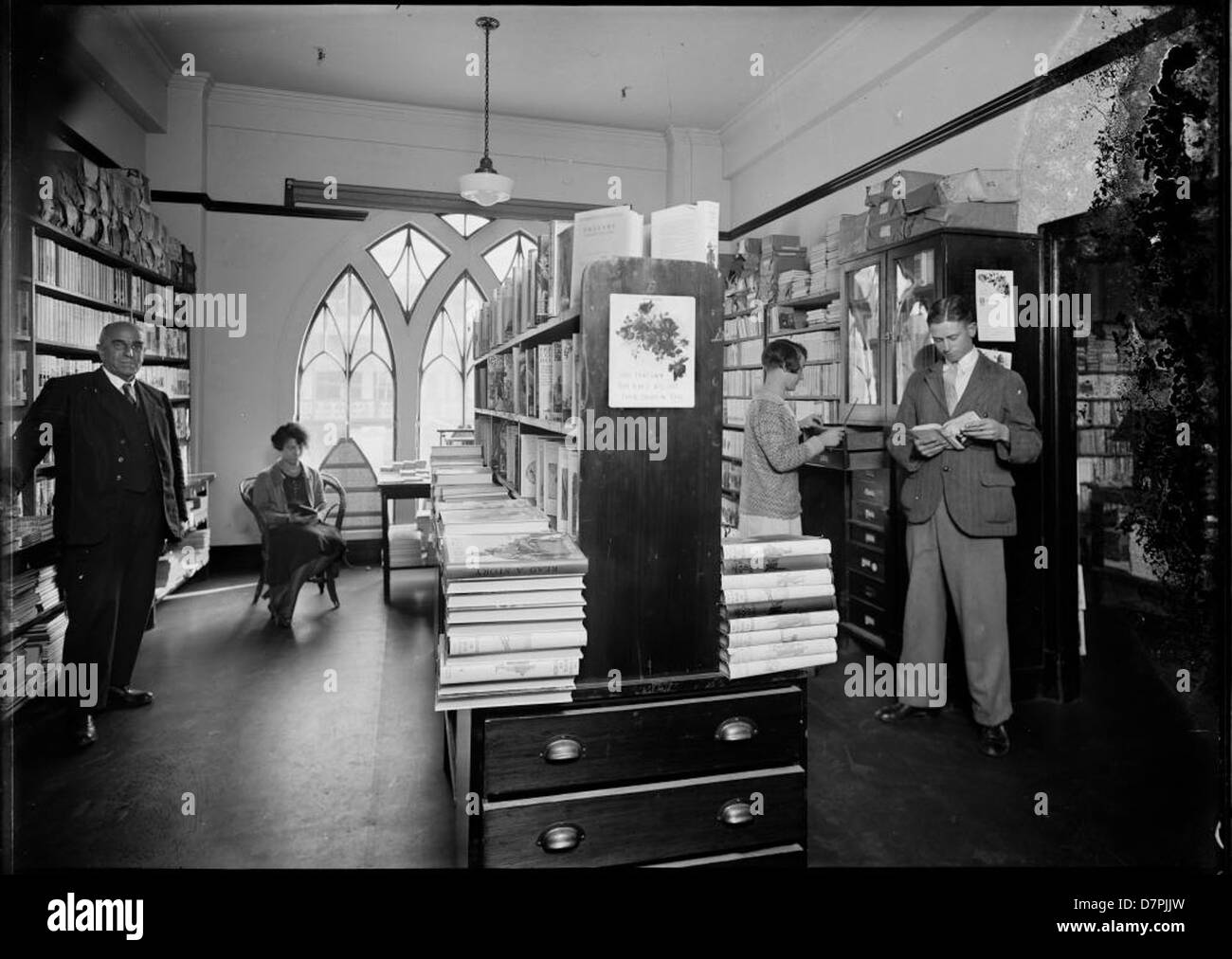 Photograph of individuals browsing in the St. Stephens Library ...