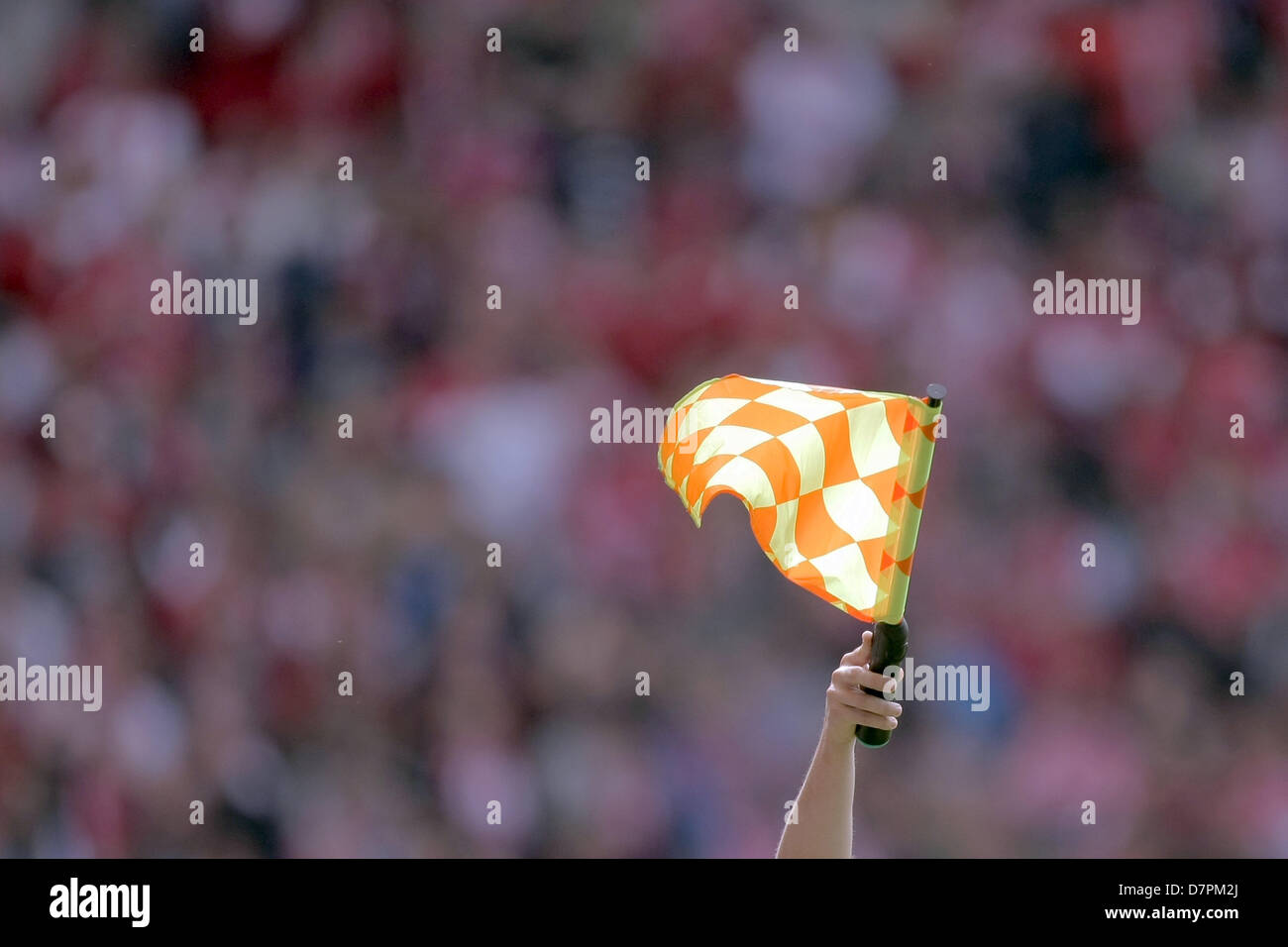 A linesman raises his flag for an offside during the Bundesliga soccer ...