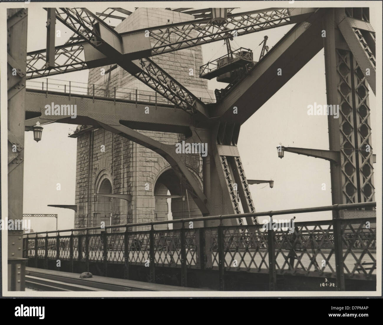 The image captures the construction of the Sydney Harbour Bridge, one ...