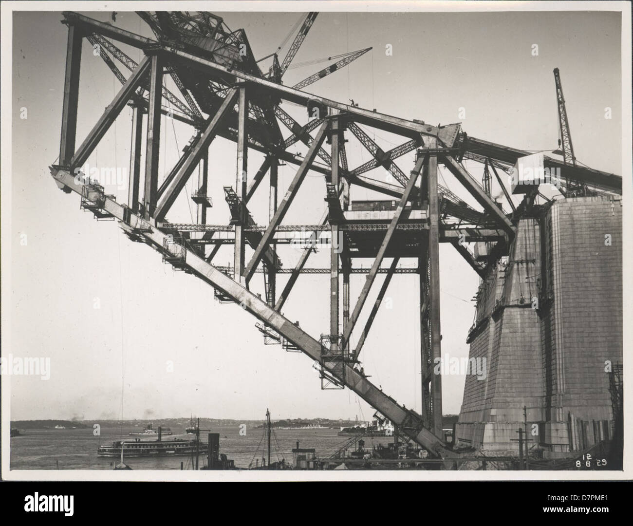 A historic photograph of the construction of the Sydney Harbour Bridge ...