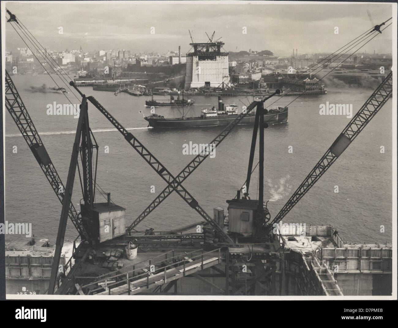 This image captures the construction of the Sydney Harbour Bridge, an ...