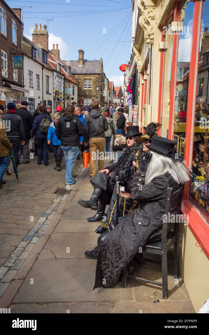 Goths sitting outside cafe during Whitby Goth weekend in April. Whitby ...