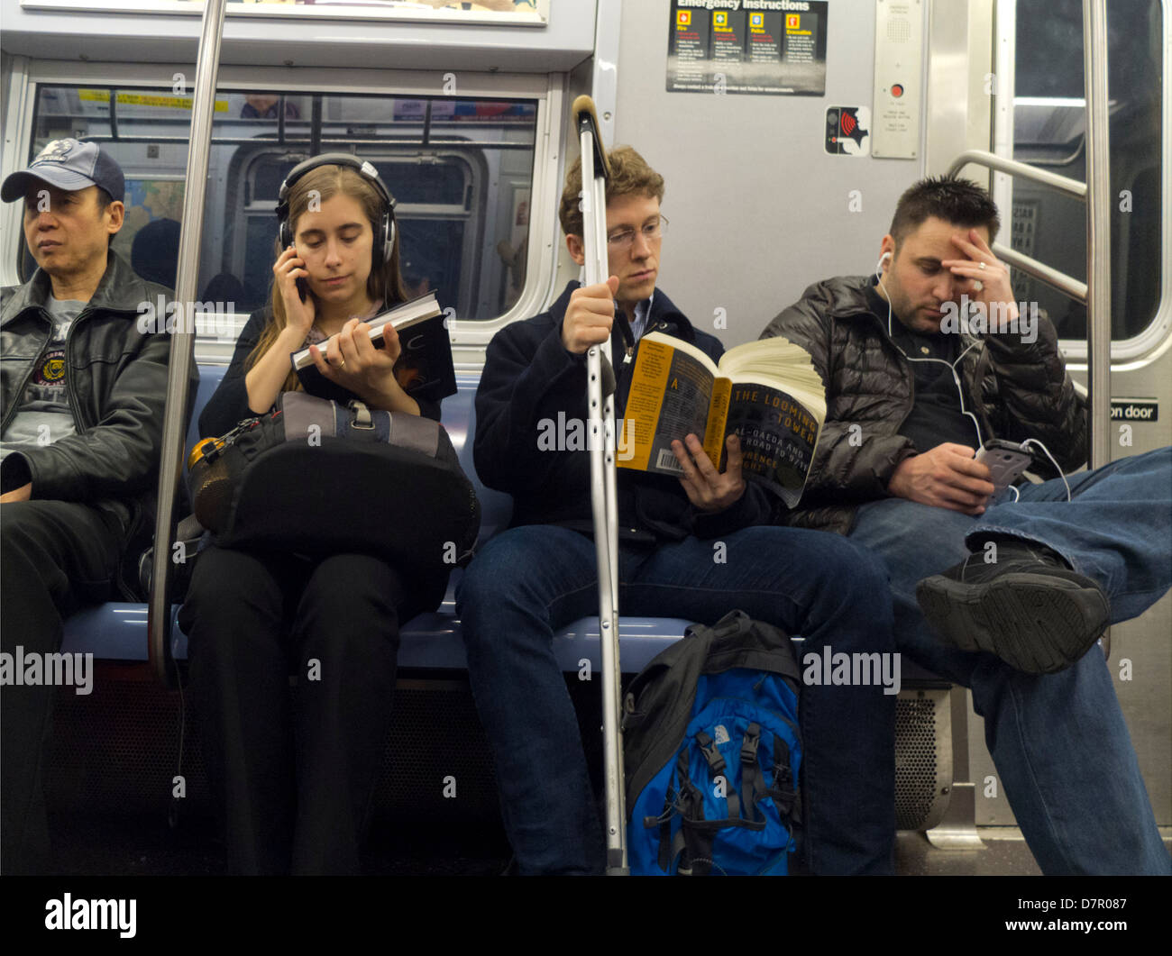 people reading on the subway Stock Photo - Alamy