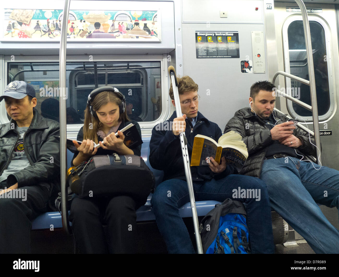 people reading on the subway Stock Photo - Alamy