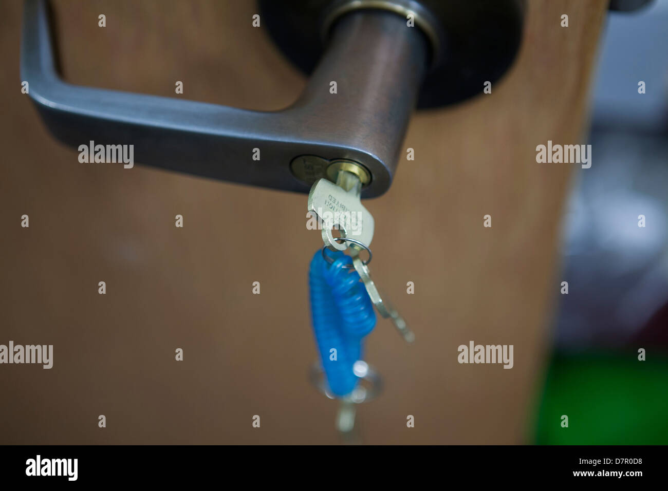 Key in office door lock Stock Photo - Alamy