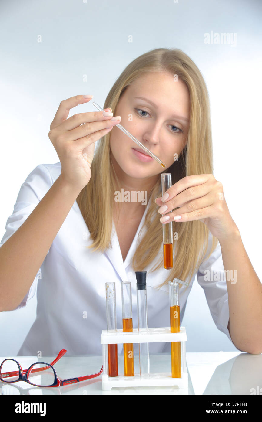 Young beautiful female scientist with flasks Stock Photo - Alamy