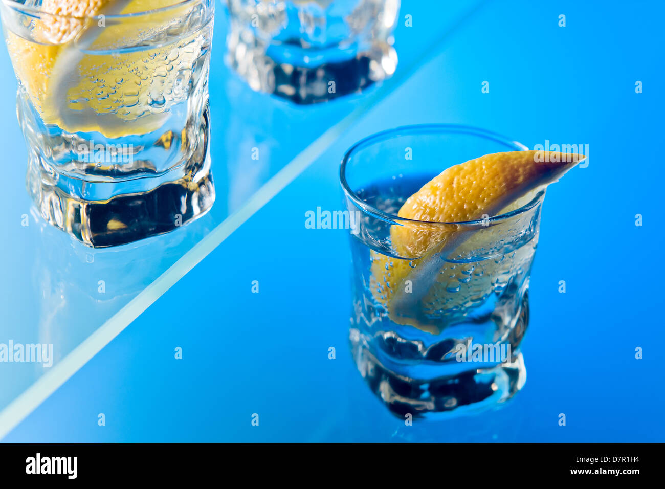 alcohol drink with lemon on a glass table Stock Photo - Alamy