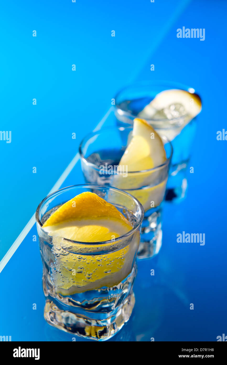 alcohol drink with lemon on a glass table Stock Photo - Alamy