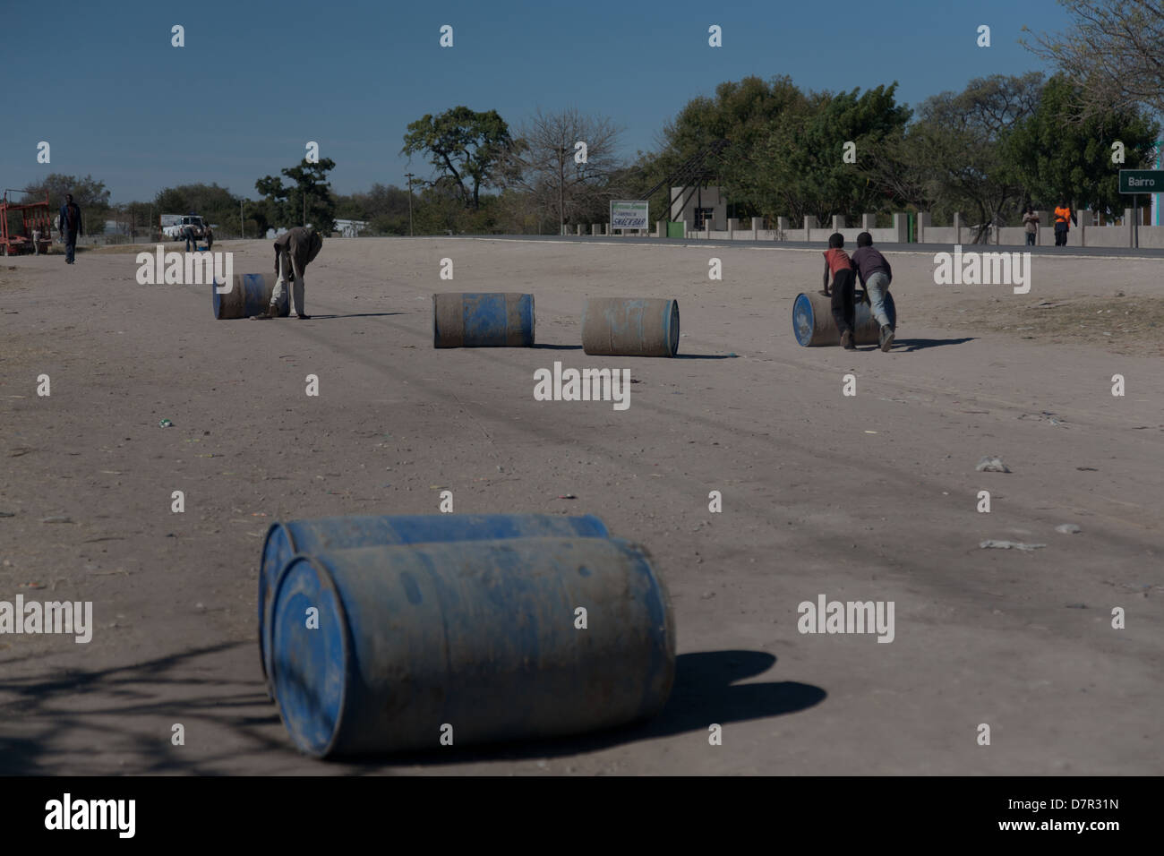 People rolling barrels of water Stock Photo - Alamy