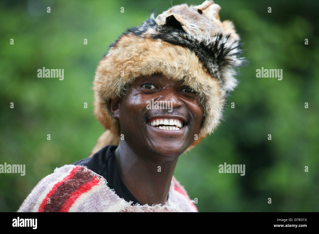 A portrait of a smiling African man wearing an animal fur hat Stock ...