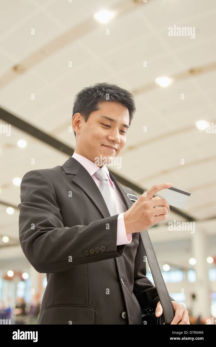Businessman Checking the Ticket Stock Photo - Alamy