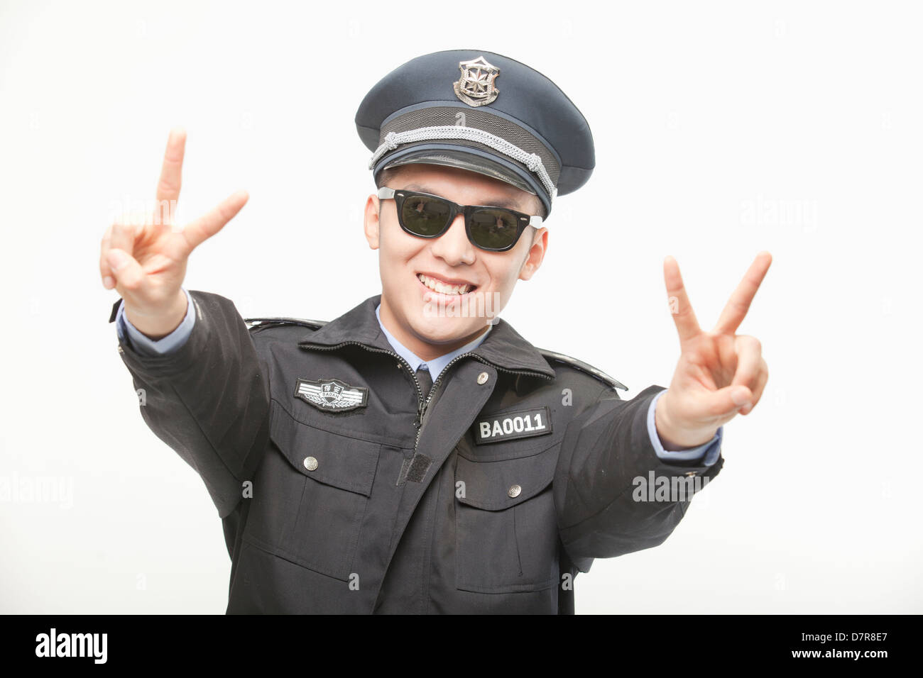 Police Officer Giving Peace Sign, Studio Shot Stock Photo - Alamy