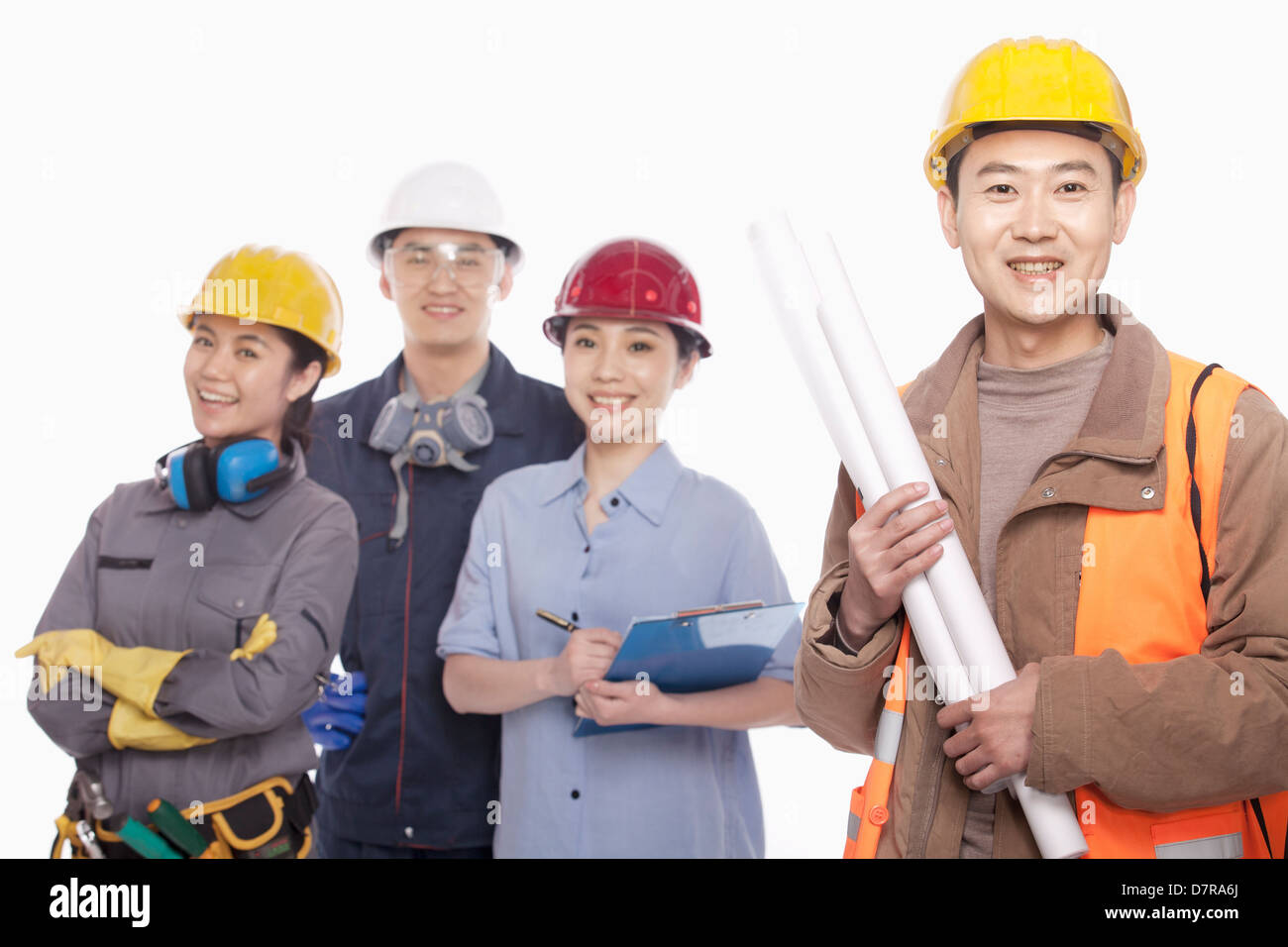Four construction workers against white background, focus in foreground ...