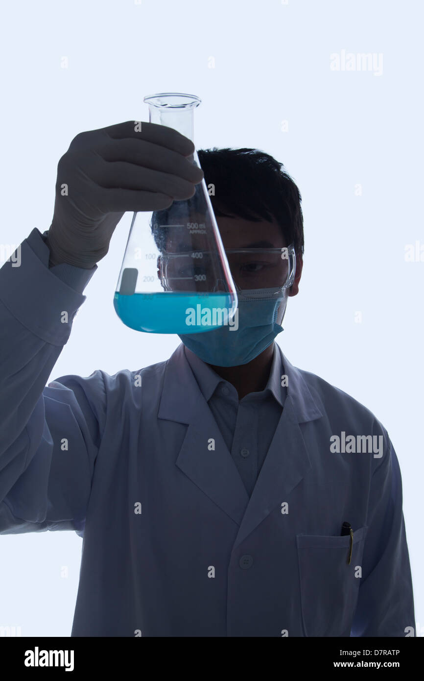 Scientist Looking at Beaker Stock Photo - Alamy