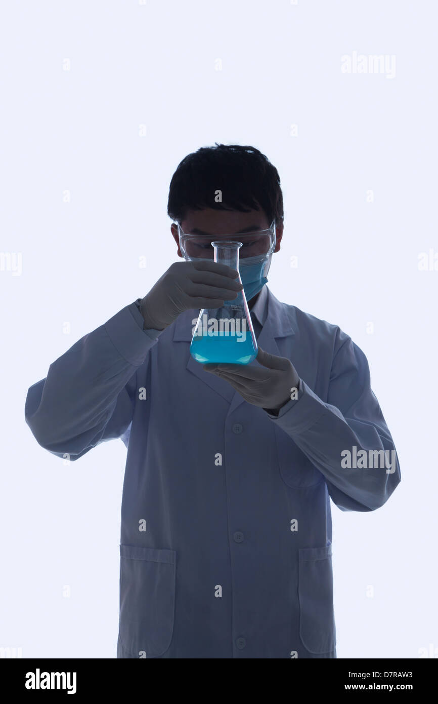 Scientist Looking at Beaker Stock Photo - Alamy