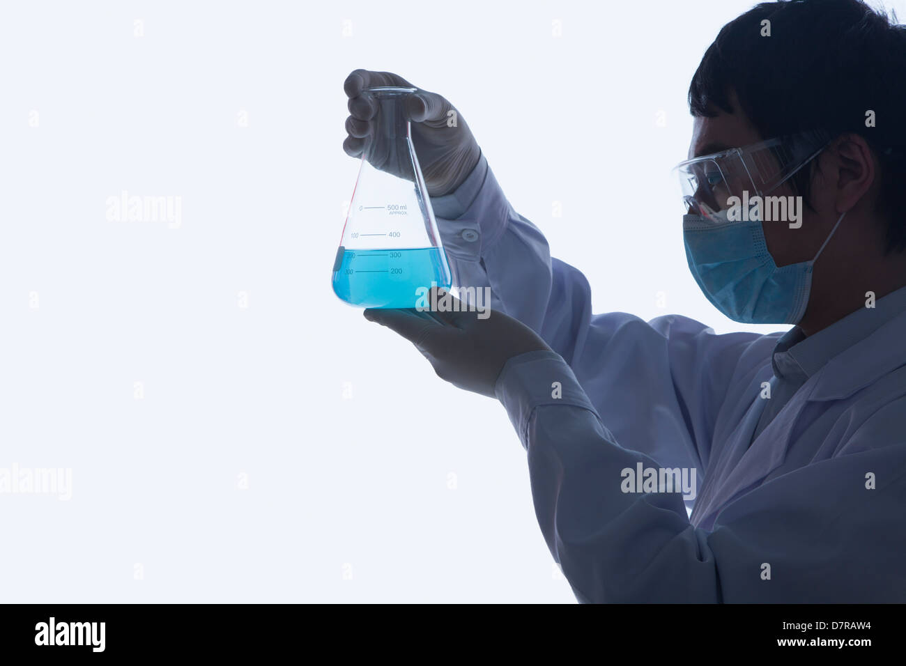 Scientist Looking at Beaker Stock Photo - Alamy