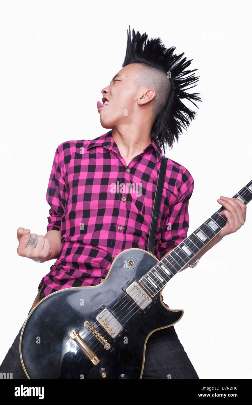 Young man with punk Mohawk playing guitar Stock Photo - Alamy