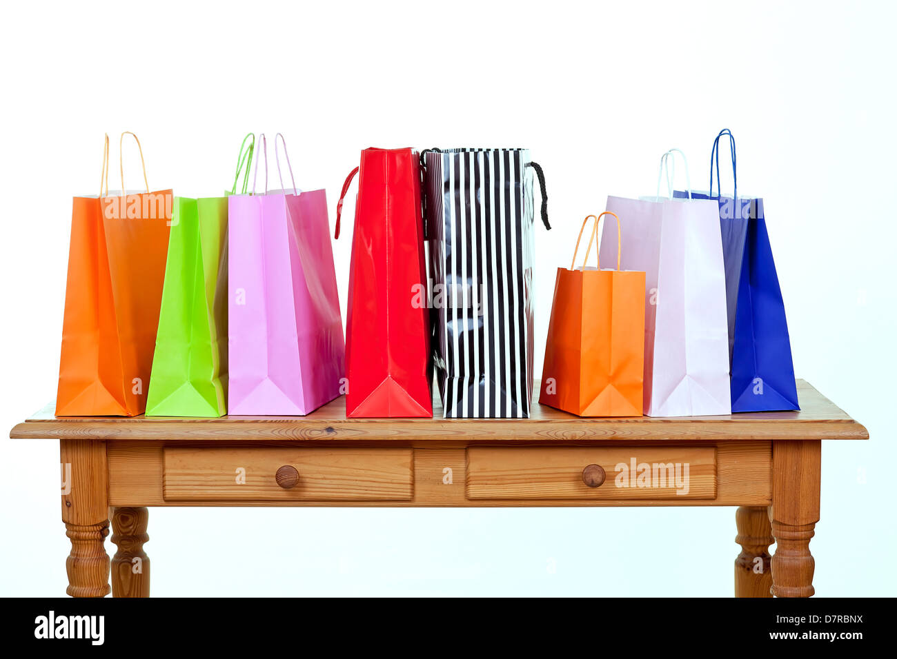 Colorful shopping bags on table Stock Photo - Alamy