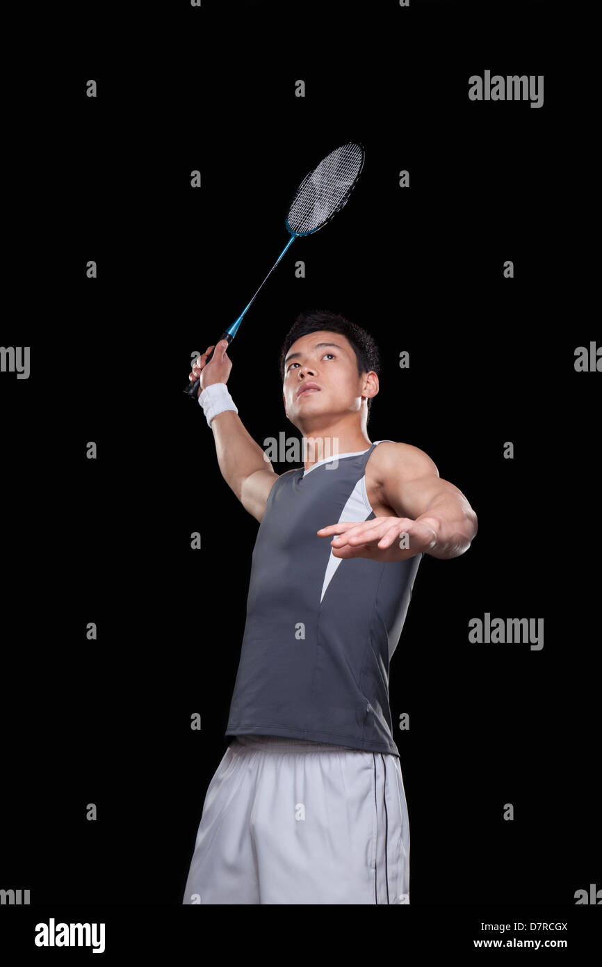 Man playing badminton, black background Stock Photo - Alamy