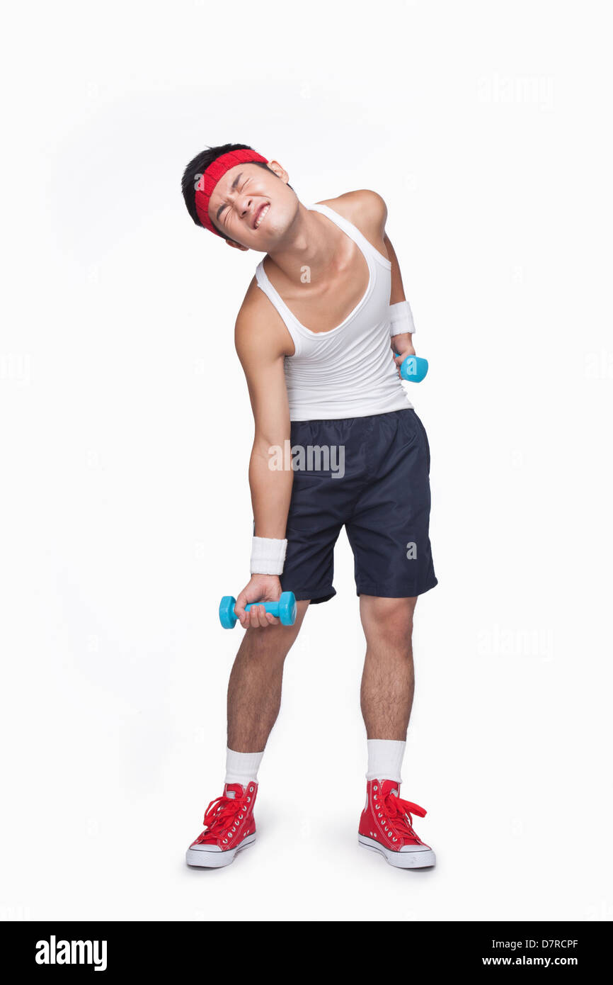 Skinny athlete lifting dumbbells Stock Photo - Alamy