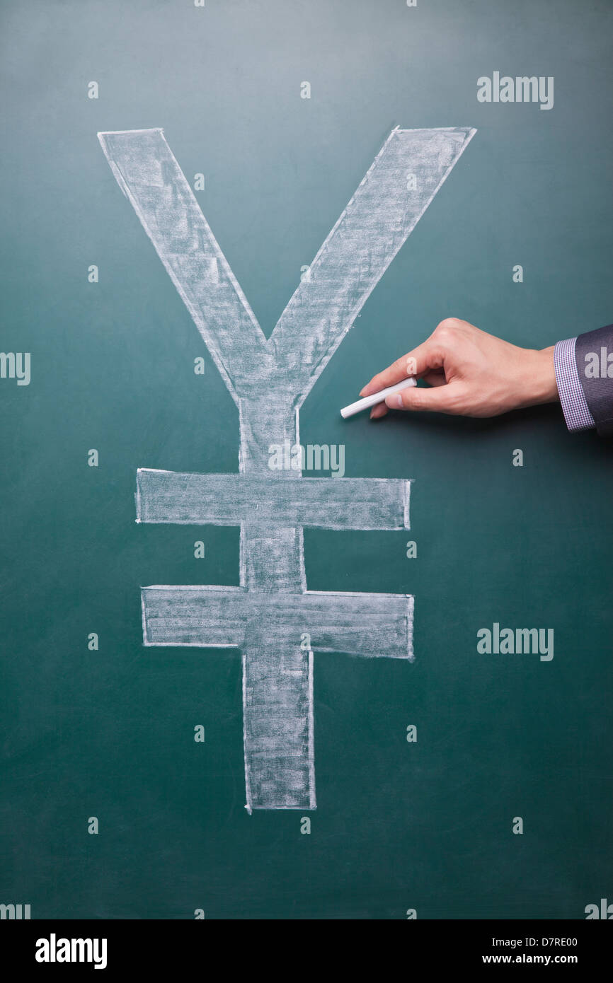 Hand drawing Yuan sign on blackboard Stock Photo - Alamy