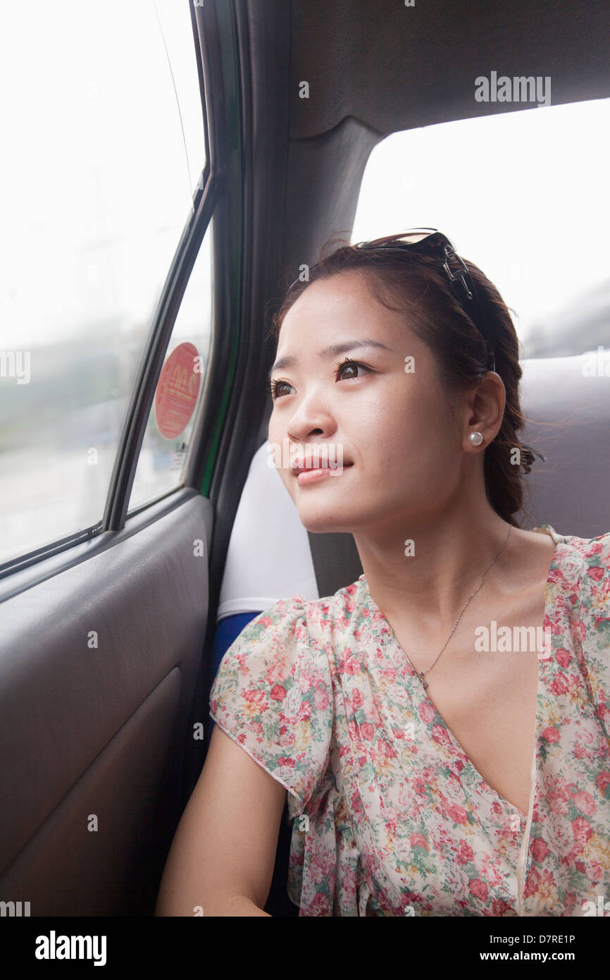 Young Woman Looking Out Window In Taxi Stock Photo - Alamy